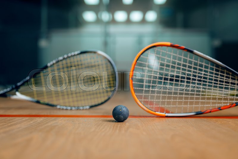 Two squash rackets and ball on court ... | Stock image | Colourbox