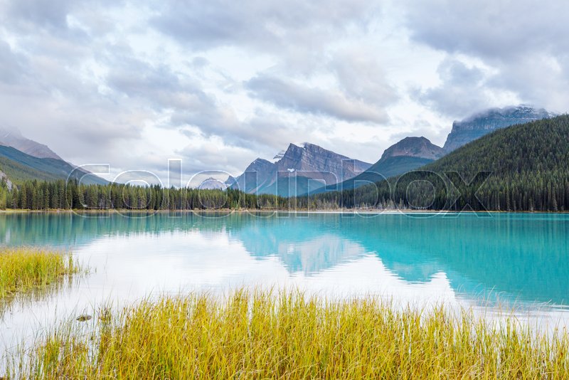 Serene scene by the mountain lake in ... | Stock image | Colourbox