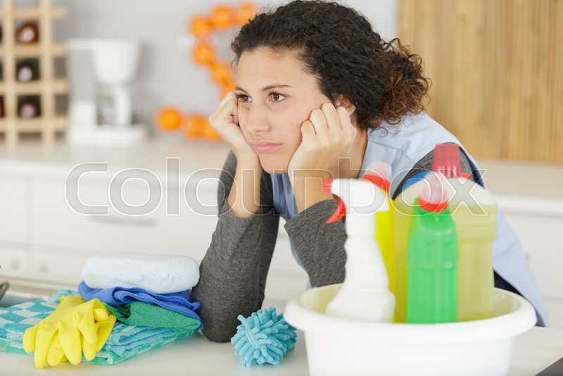 Woman boring with cleaning products | Stock image | Colourbox