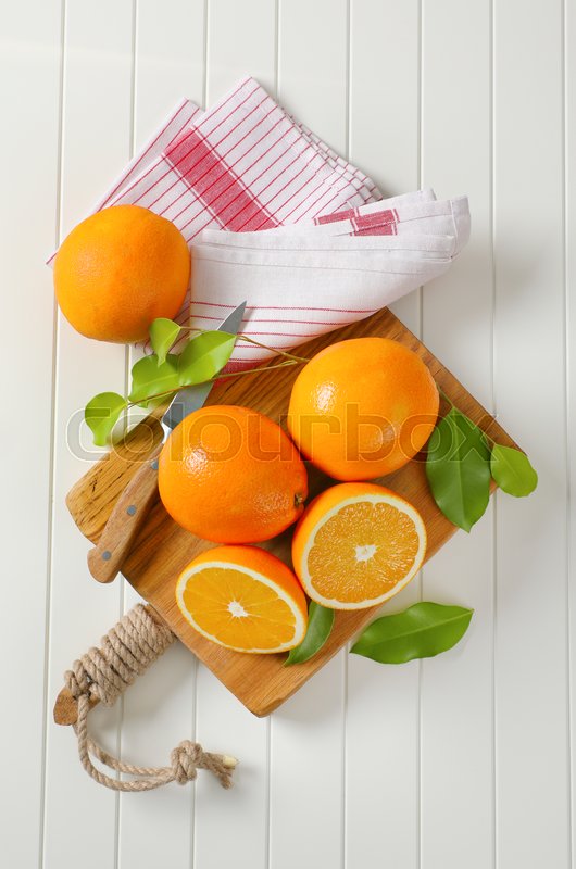 Whole ripe oranges and two halves on ... | Stock image | Colourbox
