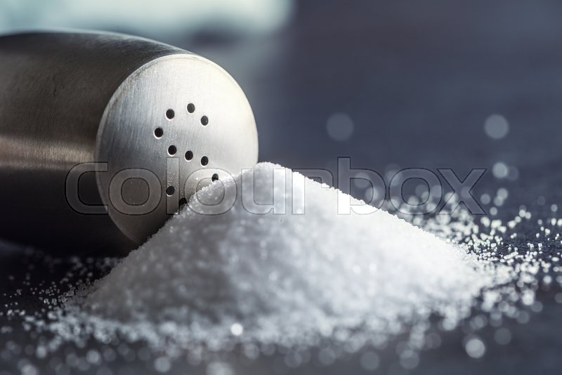 Spilled salt with staniless salt shaker ... | Stock image | Colourbox
