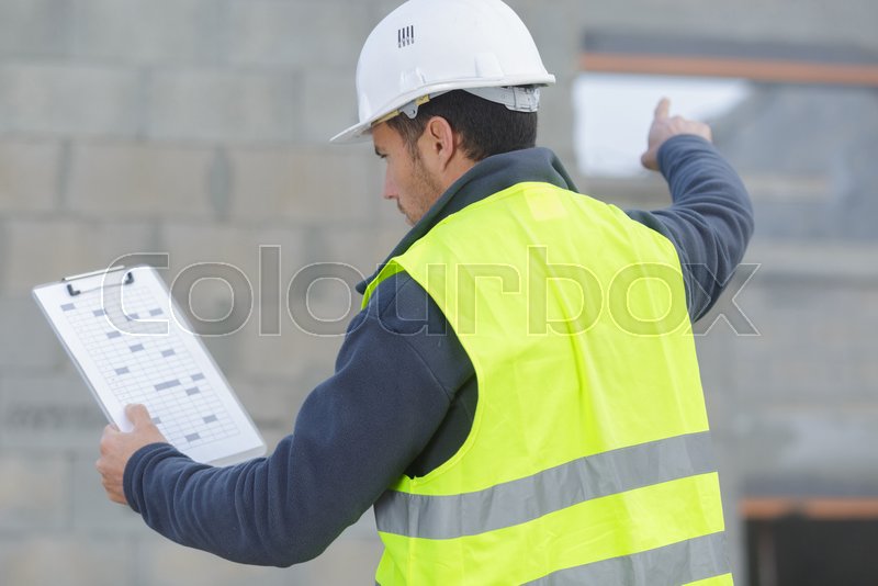 A construction worker pointing outdoors | Stock image | Colourbox