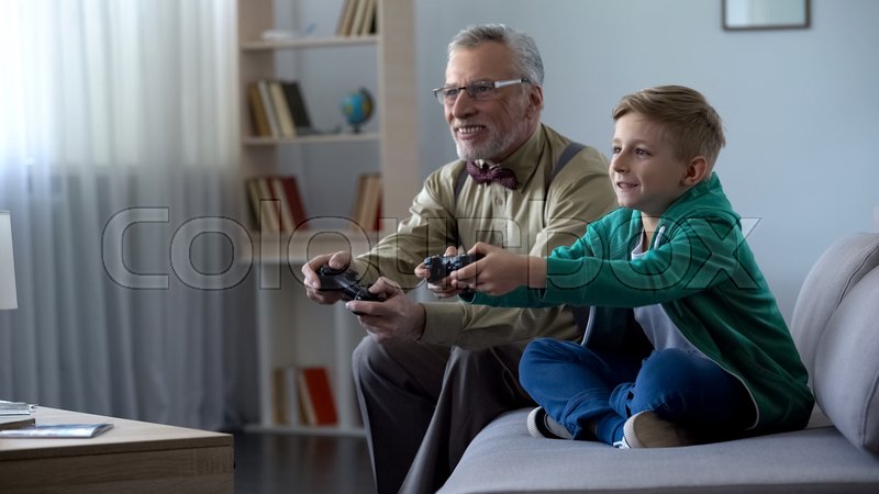 Grandfather and grandson playing video ... | Stock image | Colourbox