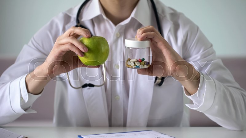 Doctor explaining vitamins benefits, ... | Stock image | Colourbox