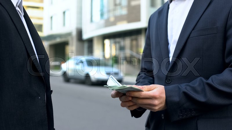 Two office workers counting money ... | Stock image | Colourbox
