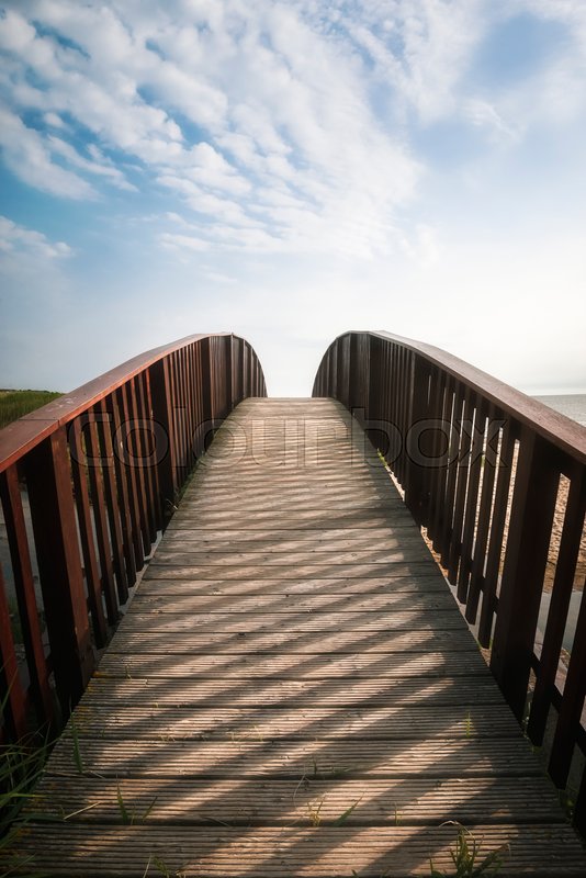 Wooden bridge over water and sand, on ... | Stock image | Colourbox