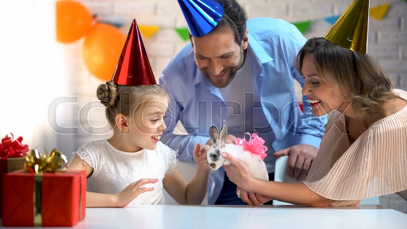 Caring parents making surprise to ... | Stock image | Colourbox