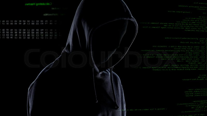 Hacker in mask and hoodie on computer ... | Stock image | Colourbox