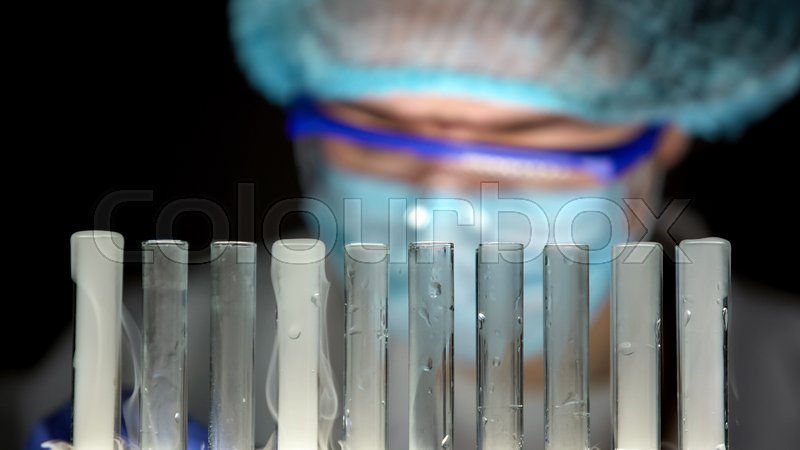 Smoke in test tubes with lab worker on ... | Stock image | Colourbox