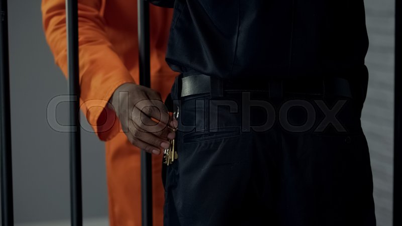 Afro-american prisoner stealing keys ... | Stock image | Colourbox