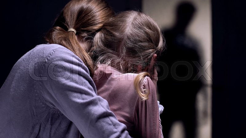 Female and kid hiding in room during ... | Stock image | Colourbox