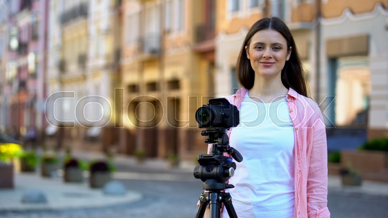 Female operator standing near camera ... | Stock image | Colourbox