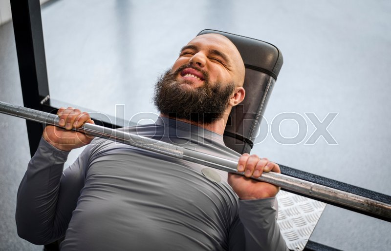 Strong man lifting weight in the gym, ... | Stock image | Colourbox