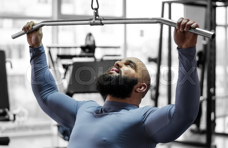 Young man working hard in gym to ... | Stock image | Colourbox