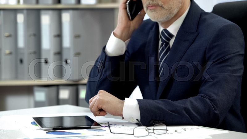 Male company director dialing, talking ... | Stock image | Colourbox