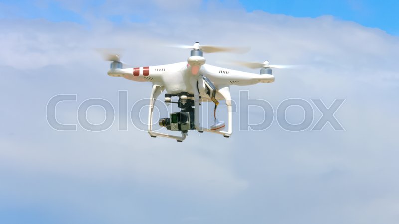 Quadrocopter with mounted camera flying ... | Stock image | Colourbox