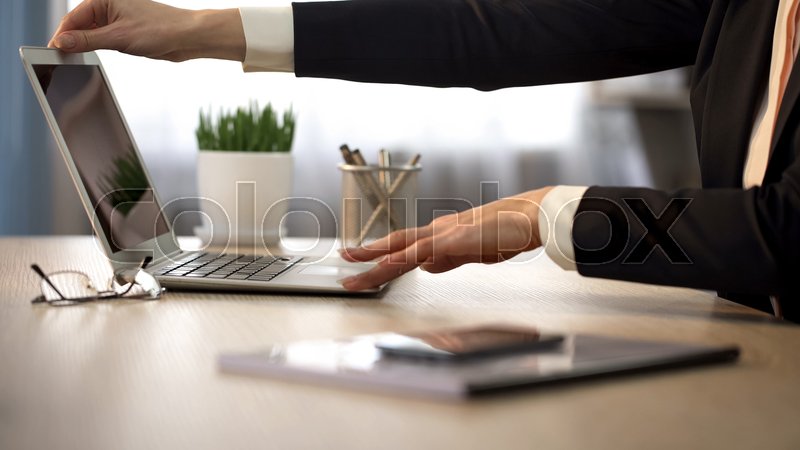 Lady opening laptop computer and ... | Stock image | Colourbox