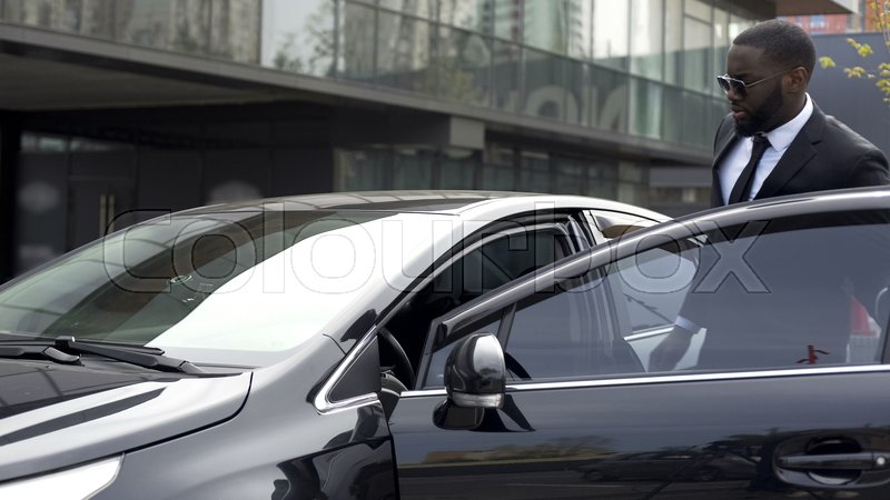 Handsome Afro-American man sitting in ... | Stock image | Colourbox