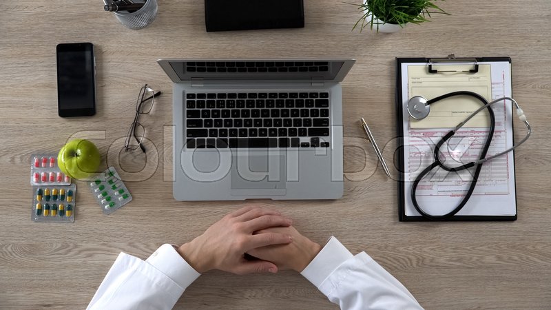 Physician at working place in clinic, ... | Stock image | Colourbox