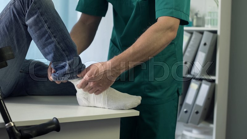 Physical therapist putting cast gypsum ... | Stock image | Colourbox