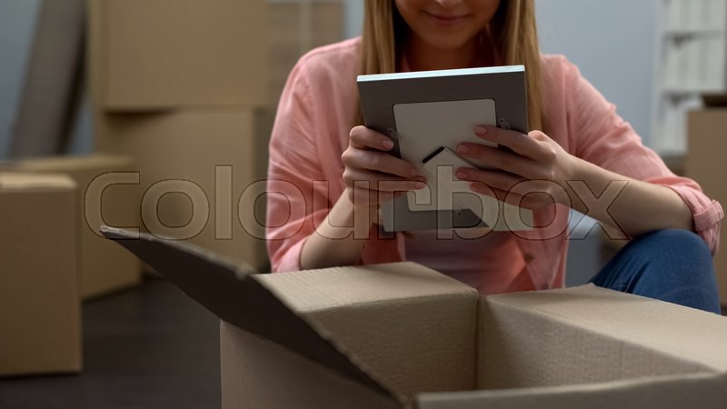 Happy student unpacking things in ... | Stock image | Colourbox