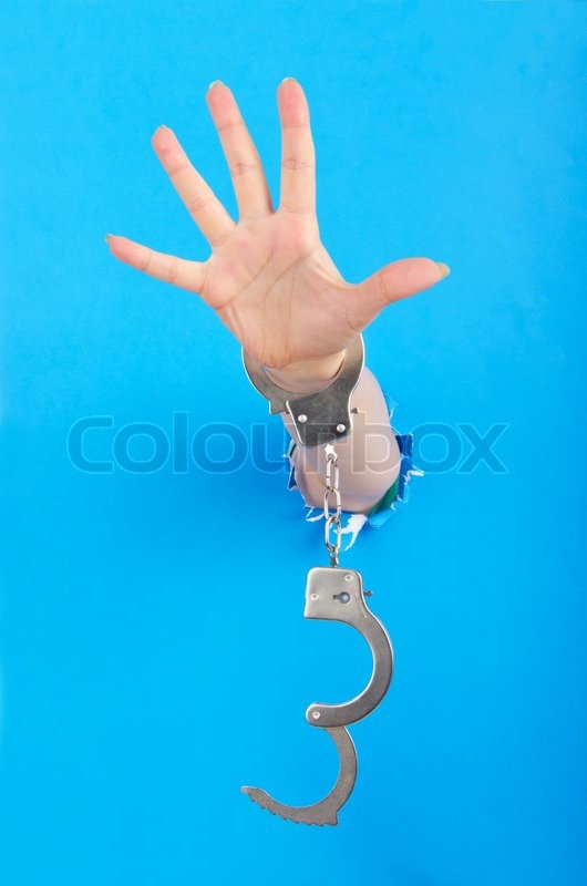 Hand with handcuffs out of paper | Stock image | Colourbox