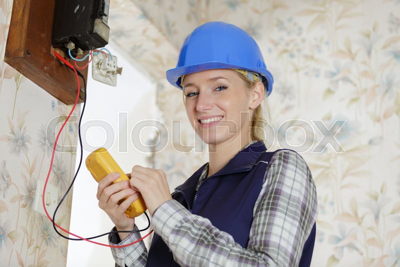 Portrait of female electrician using ... | Stock image | Colourbox
