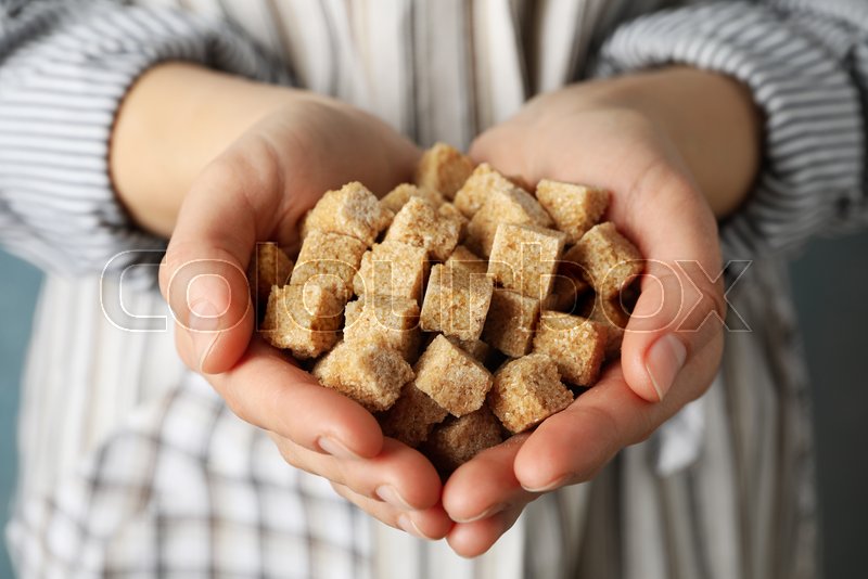 Woman holding sugar cubes in hands, ... | Stock image | Colourbox