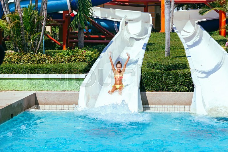 Child having fun on water slide at ... | Stock image | Colourbox