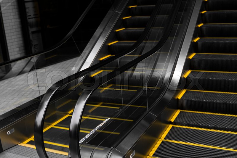 Empty escalators stairway with a yellow ... | Stock image | Colourbox
