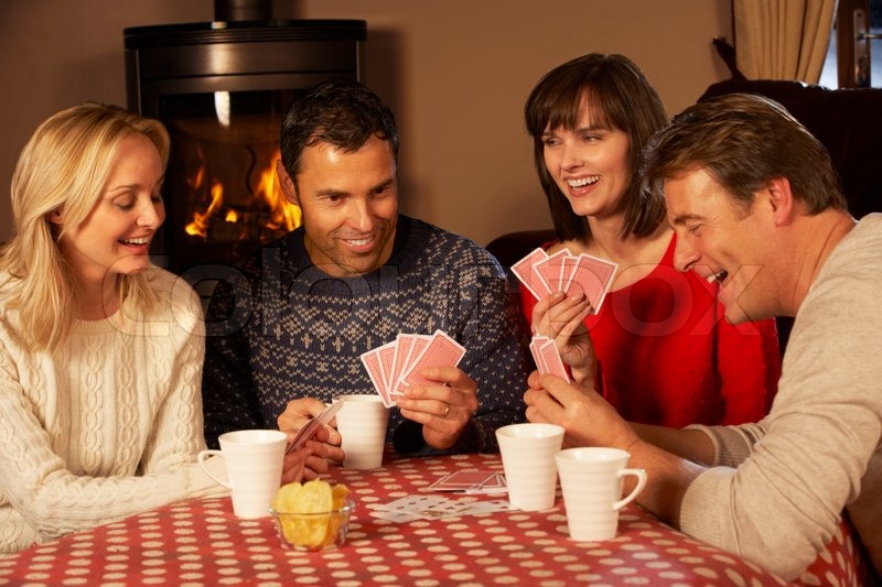 Group Of Middle Aged Couples Playing Cards Together | Stock Photo ...