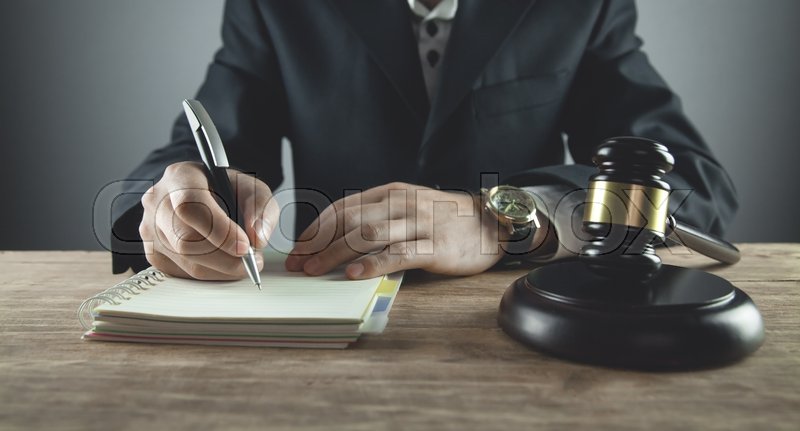 Judge gavel on the table. Judge writing ... | Stock image | Colourbox