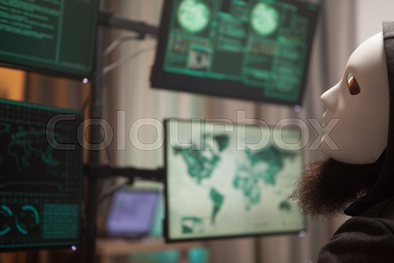 Hacker wearing a white mask to protect ... | Stock image | Colourbox