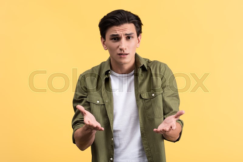 Angry young man with shrug gesture, ... | Stock image | Colourbox