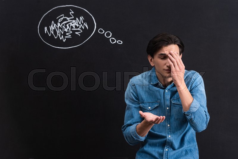 Confused young man with thought bubble ... | Stock image | Colourbox