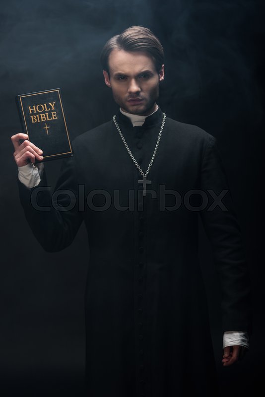 Young strict catholic priest showing ... | Stock image | Colourbox