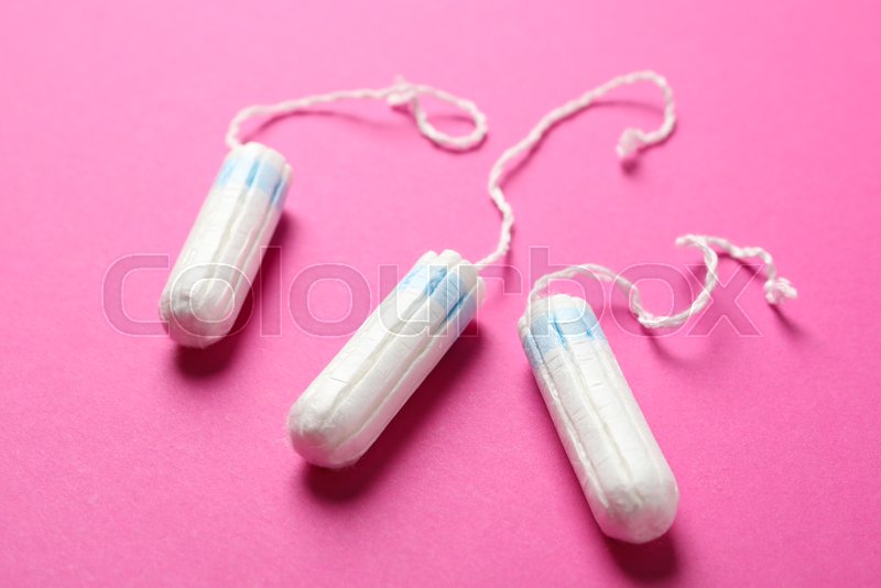 Three tampons on pink background, close ... | Stock image | Colourbox