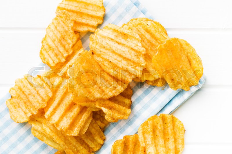 Crinkle cut potato chips on table. ... | Stock image | Colourbox