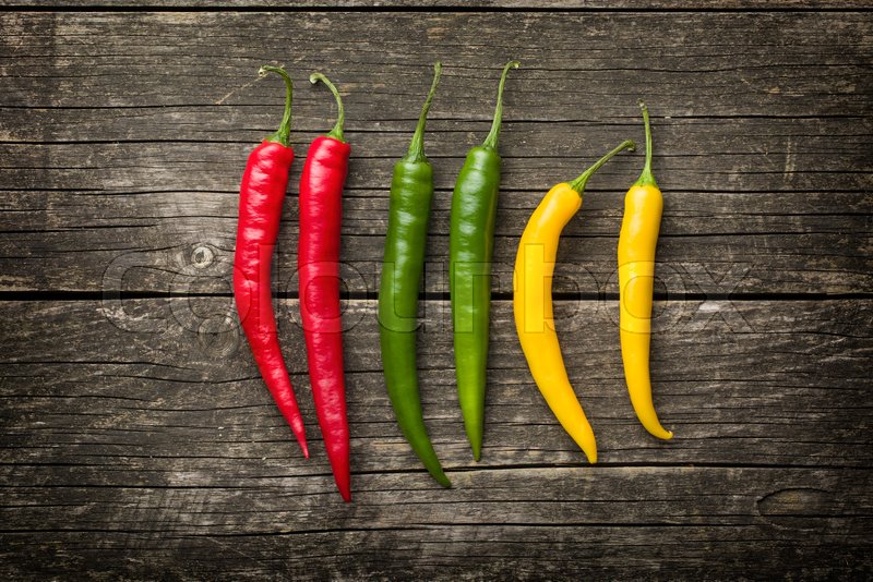 Different colors chilli peppers on old ... | Stock image | Colourbox
