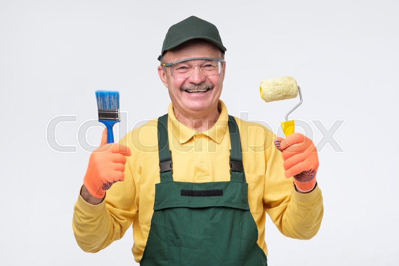 Painter senior man at work with a paint ... | Stock image | Colourbox