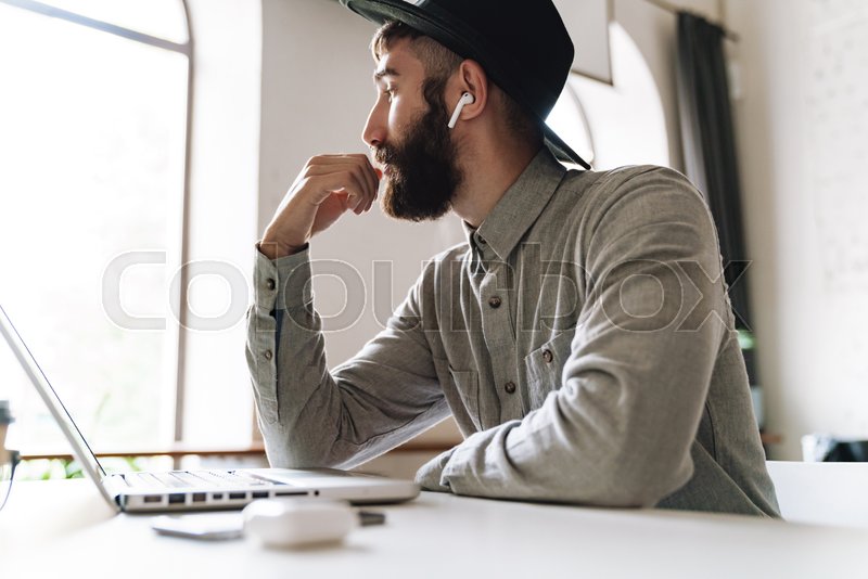 Photo of thinking young man wearing hat ... | Stock image | Colourbox