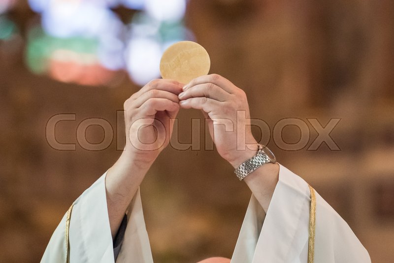 Minister showing the holy bread during ... | Stock image | Colourbox