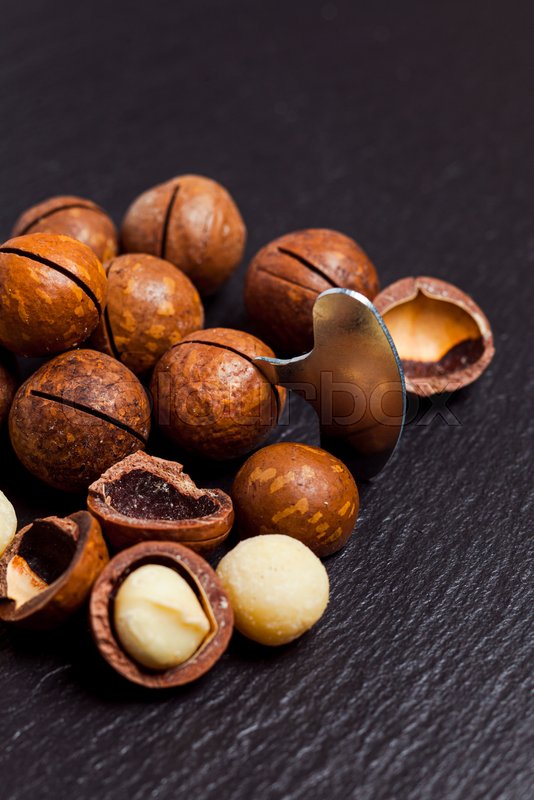 Whole and open macadamia nuts with key ... | Stock image | Colourbox