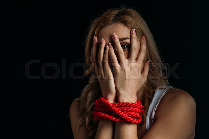 Scared victim with tied hands looking ... | Stock image | Colourbox
