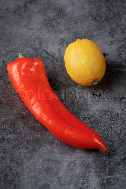 A fresh lemon with a chili pepper. | Stock image | Colourbox