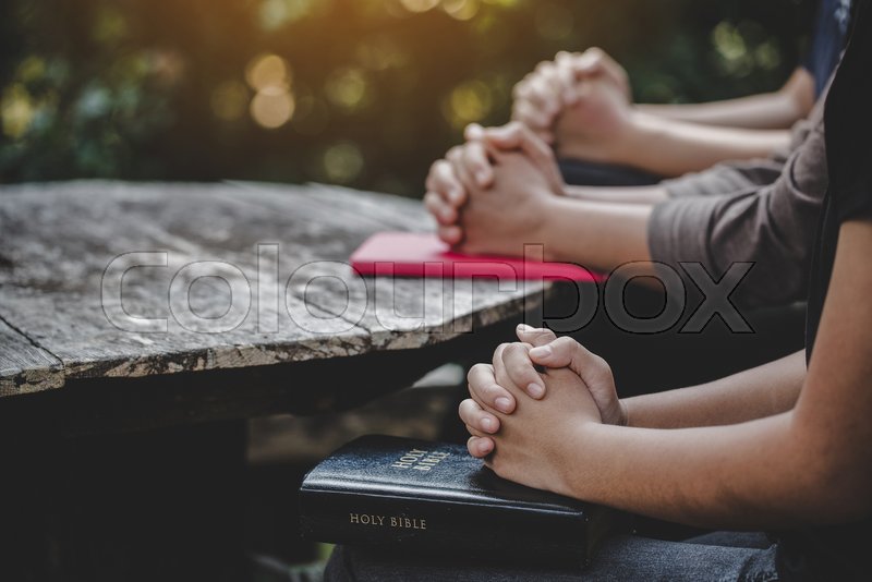 Group of different women praying ... | Stock image | Colourbox