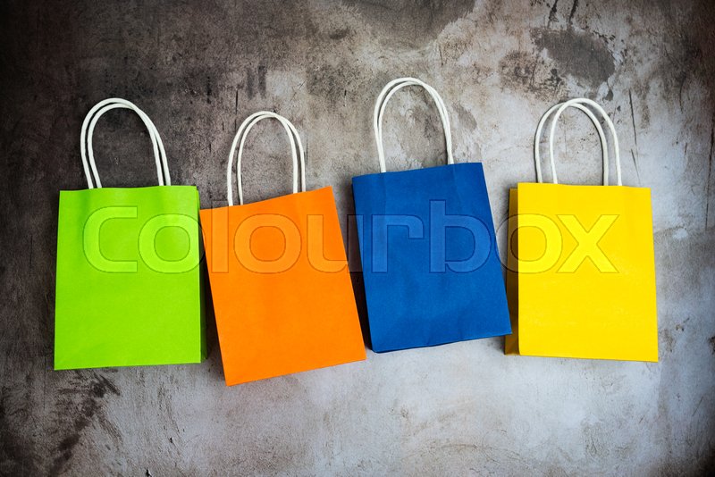 Four colorful shopping bags in a row ... | Stock image | Colourbox
