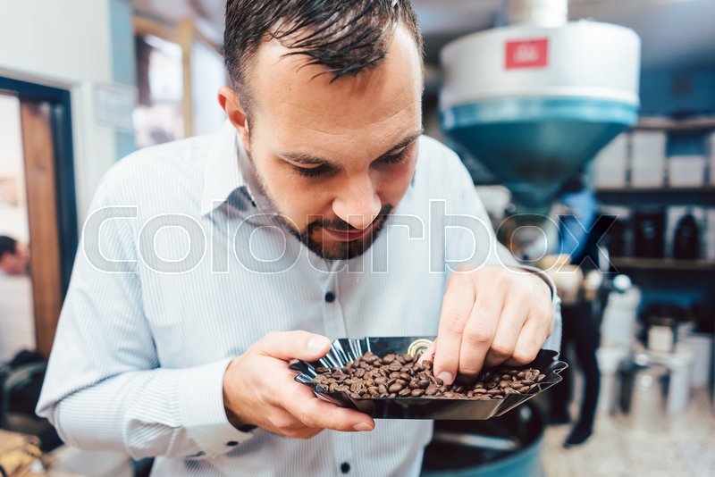 Man with freshly roasted coffee beans ... | Stock image | Colourbox