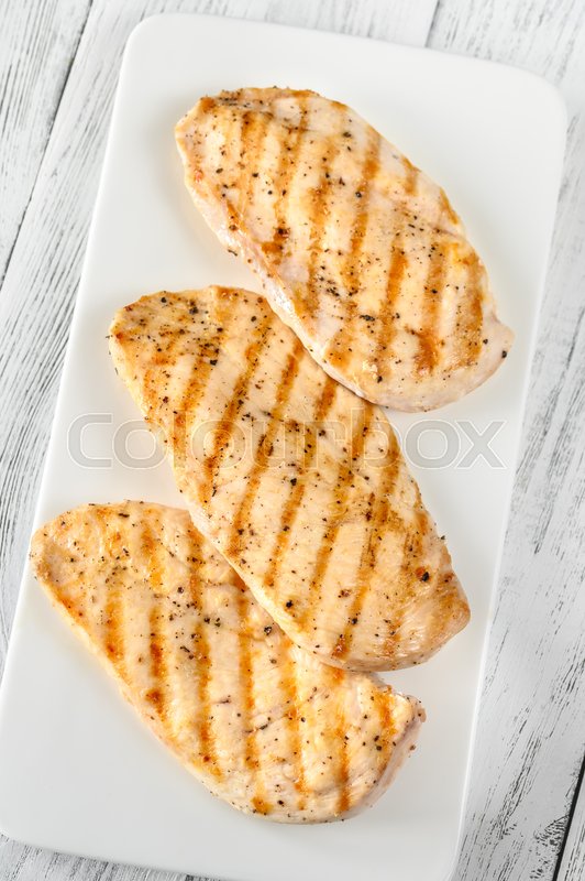 Grilled chicken on serving plate: top ... | Stock image | Colourbox