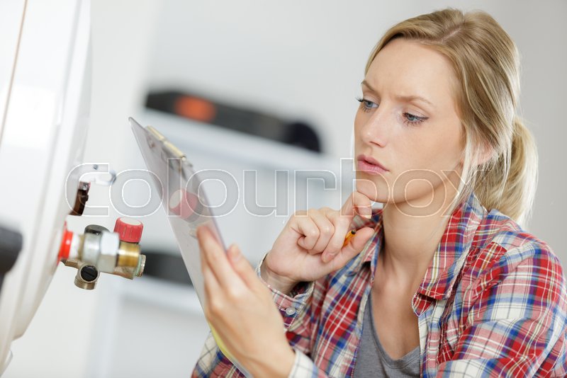Portrait of female plumber working on ... | Stock image | Colourbox